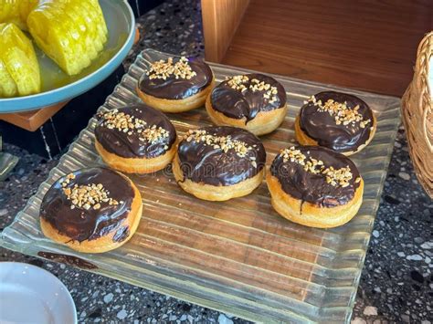 Assorted Chocolate Frosted Donuts With Sprinkled Toppings On A Decorative Plate Stock Image