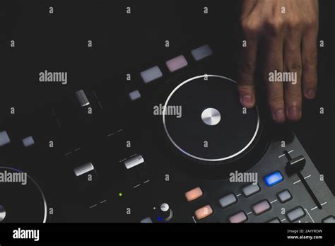 DJ Plays Music Sound Mixer Controller With Knobs And Sliders Close Up Hands On The Mixing Deck