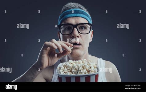 Funny Guy With Glasses And Headband Watching Movies He Is Staring At
