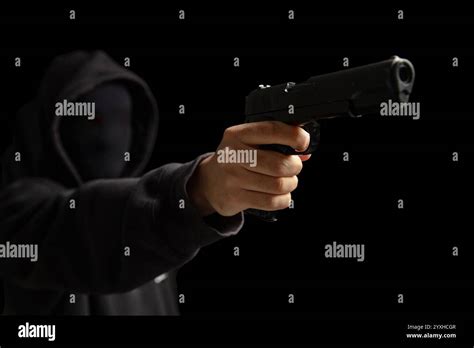 Robber Wearing Black Hood Holding Gun Ready To Shoot Armed Gangster