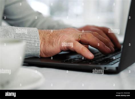 Closeup Of Senior Man Hands Using Laptop Cropped Side View Of Wrinkled Caucasian Older Hands