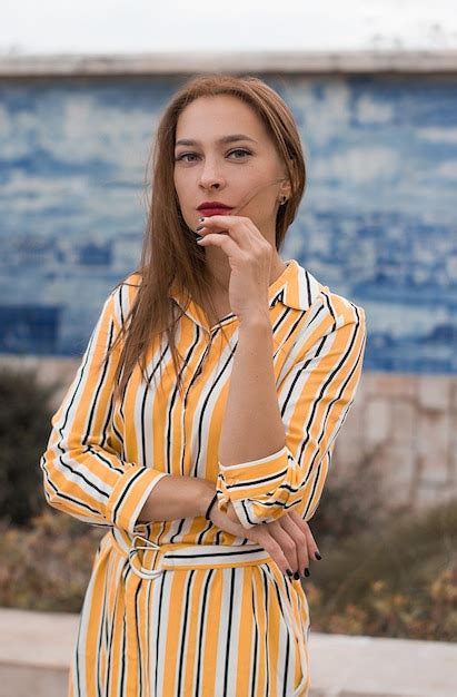 Young Woman Standing Against Wall Premium Photo