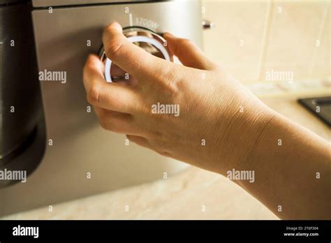 Hand Using Girl Adjusting Temperature Of Microwave Oven Using Microwave Oven Power Regulator