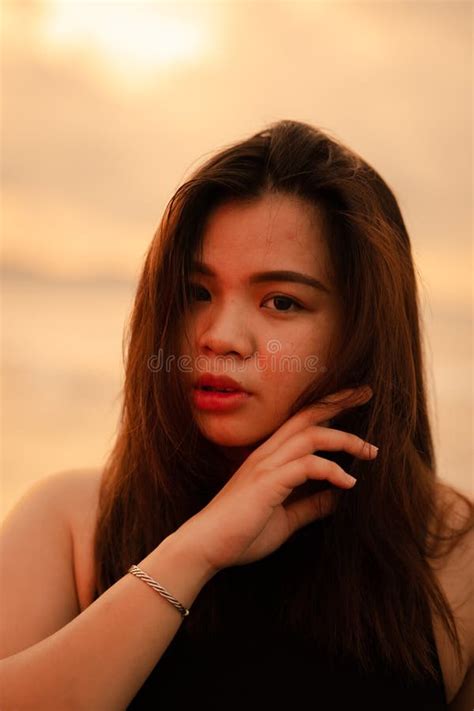 A Beautiful And Asian Woman With Flat Facial Expressions And Posing