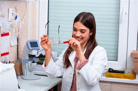 Optician Repairing Spectacles With Tool In Optical Store Stock Image