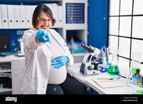 Pregnant Woman Working At Scientist Laboratory Pointing Displeased And