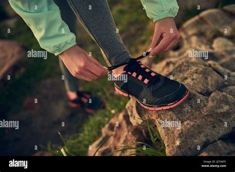 Shes Almost Ready To Go An Unrecognizable Woman Tying Her Shoe Laces