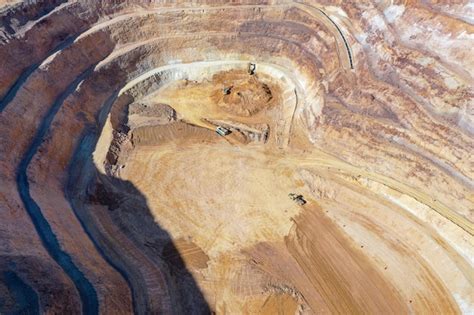 Premium Photo Open Pit Mine In Full Operation With Machinery Extracting Minerals