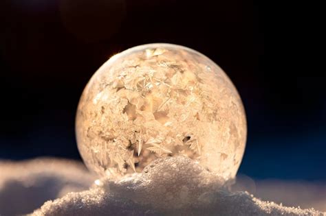 Premium Photo Soap Bubble In The Snow In Winter Ice Patterns On The Surface