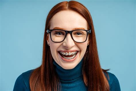 Premium Photo Redhead Woman With Braces Donning Glasses Laughing