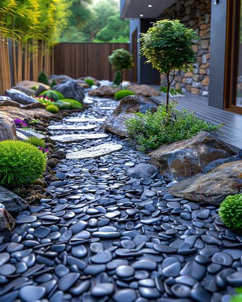 Small Stream Or Small Waterfall Flowing Through Beautiful Garden Stock