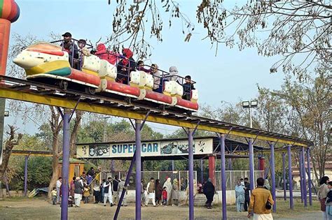 People Enjoying Mini Train Ride At Lake View Park