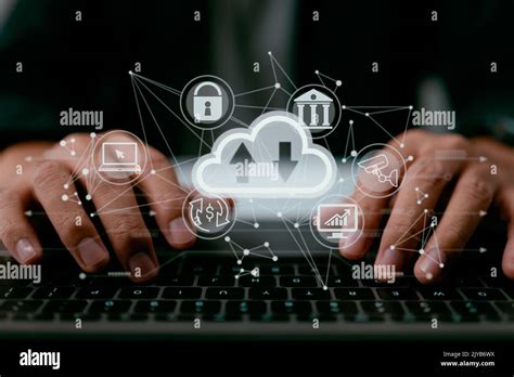 A Man Uses A Laptop That Displays A Schematic Of Cloud Computing Data