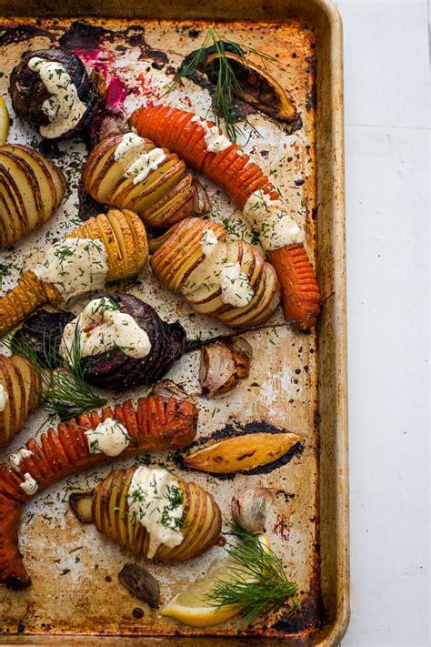 Garlic Hasselback Potatoes And Root Vegetables With Yoghurt Dill
