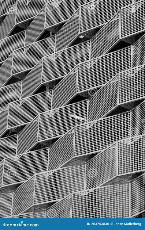 Modern Steel Cladding With Angular Geometric Patterns And Square Holes In A Shiny Metal Stock