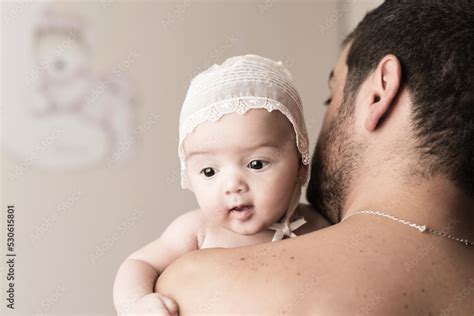 Shirtless Father Catches His Daughter With Baptism Ceremonial Cap Stock