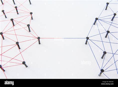 Connecting Networks Concept Two Network Connected With Yarn Red And Blue On White Paper