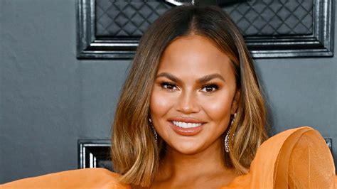 Download Chrissy Teigen Orange Dress Smile Wallpaper
