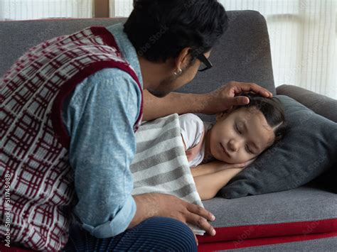 Father Lovingly Tuck Cute Little Daughter To Sleep On Sofa In The