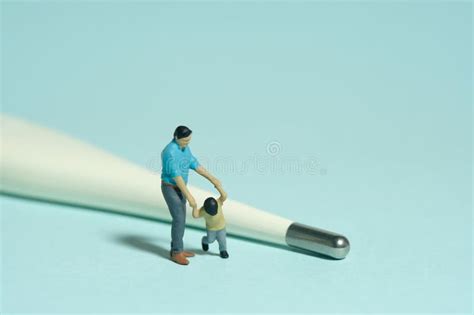 A Father And Son Standing In Front Of Thermometer Isolated Blue