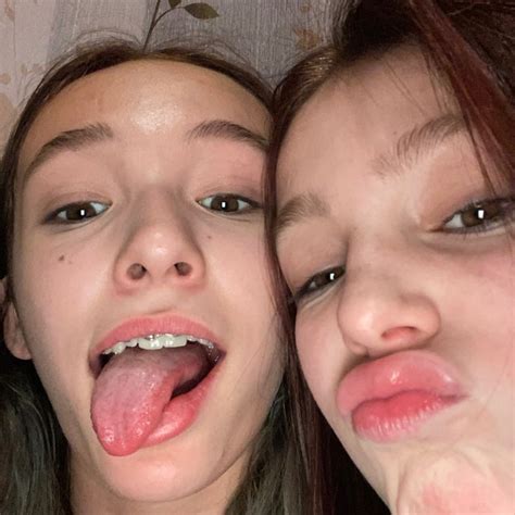Two Girls Sticking Their Tongue Out And Making Faces