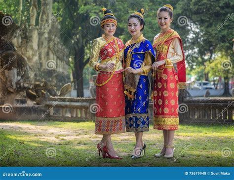 Laos Girl In Lao Traditional Clothing Goes On A Wooden Bridge Over The