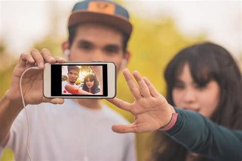 Premium Photo Man Photographing Woman Using Mobile Phone