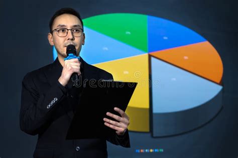 Businessman Doing Presentation Using Tablet And Pie Chart On Big