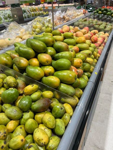 Premium Photo A Collection Of Yellow And Red Mangoes Displayed In A