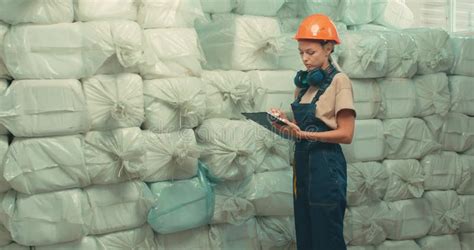Young Female Factory Worker Using Counting Chemical Barrels Making