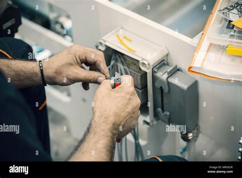 Electrician Connecting Wires To The Junction Box Stock Photo Alamy
