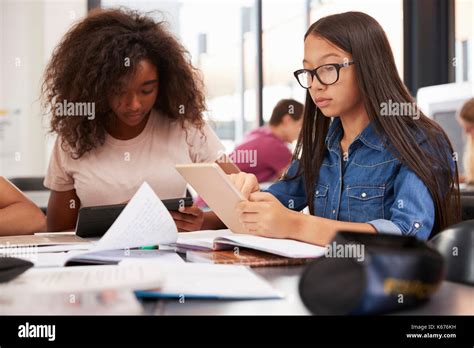 Two Teenage Babegirls Using Tablet Computers In Class Stock Photo Alamy