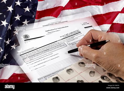 Man With American Citizenship Application On Usa Flag Concept
