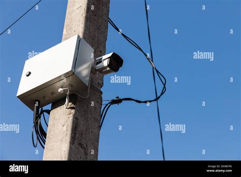 Closed Circuit Television Camera Is Mounted On Concrete Street Pole Under Blue Sky Cctv