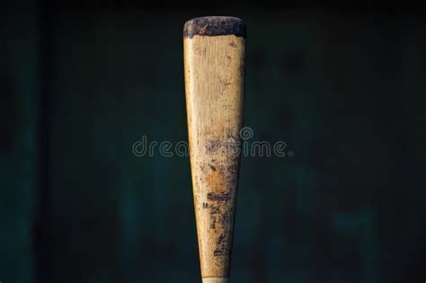 Vintage Wooden Baseball Bat Resting Against A Dark Background In A