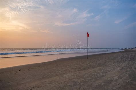 Red Flag On Beach On Sea Or Ocean At Sunset As Symbol Of Danger The Sea State Is Considered
