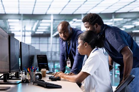 Teamworking Technicians Reconfiguring Server Farm Premium Photo
