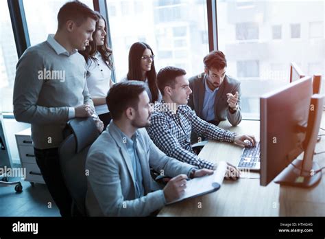 Software Engineers Developing Applications Together In Office Stock