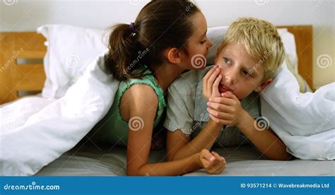 Siblings Interacting With Each Other On Bed In Bedroom Stock Footage