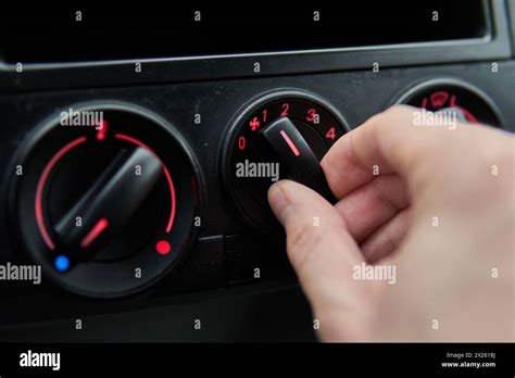 Man Hand Turns The Climate Heater Control Wheel In A Car Temperature And Blow Air Conditioner