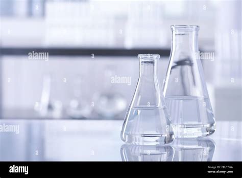 Conical Flasks With Transparent Liquid On Table In Laboratory Space For Text Stock Photo Alamy