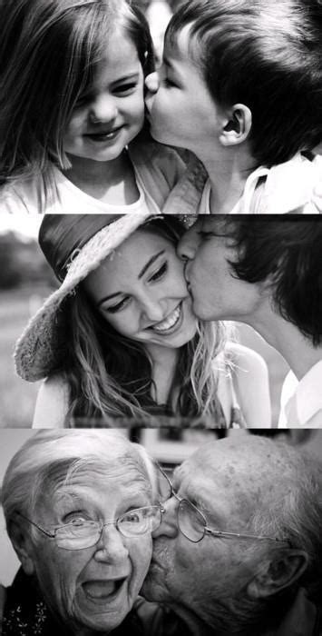 An Older Man Kissing A Young Woman While She Kisses Her Face On The