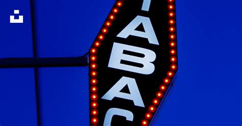 A Taco Sign Lit Up Against A Blue Sky Photo Free France Image On Unsplash