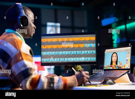 Black Man Photo Editor In A Well Organized Workspace Editing Images On Dual Monitors Using