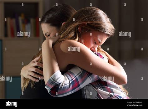Two Sisters Hugging Sadly