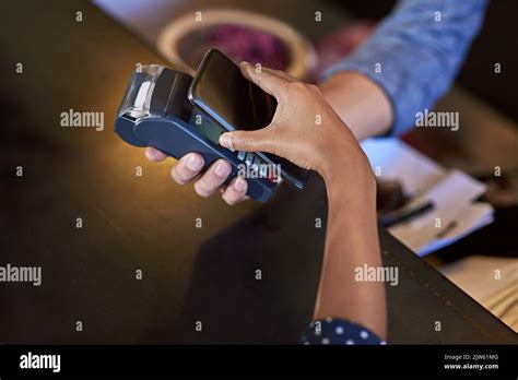 Simplifying Spending A Woman Paying Using Nfc Technology In A Cafe