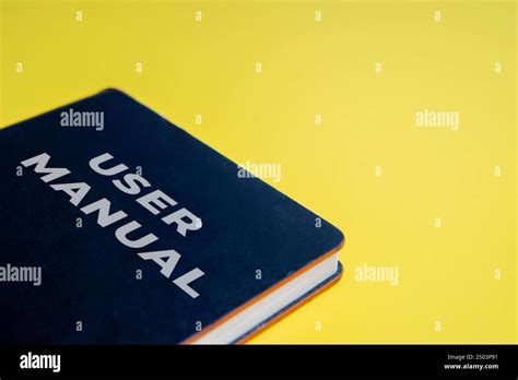 A Close Up Image Of A User Manual Book On A Bright Yellow Background