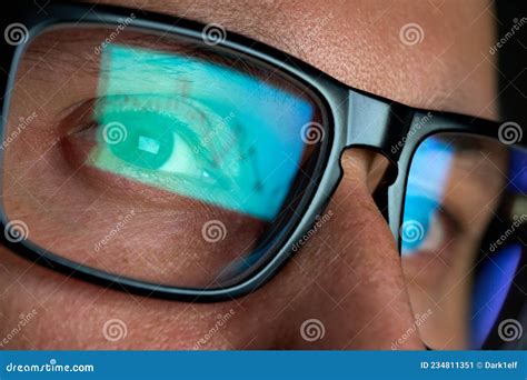 Trader Looking At Computer Screen Analyzing Trading Chart Reflecting In