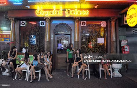 Thai Bar Girls Wait For Customers In Front Of A Bar At The Deserted