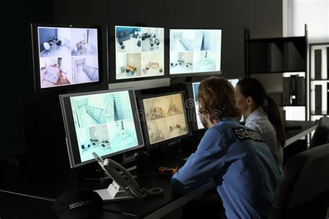 Security Guards Monitoring Modern Cctv Cameras In Surveillance Room
